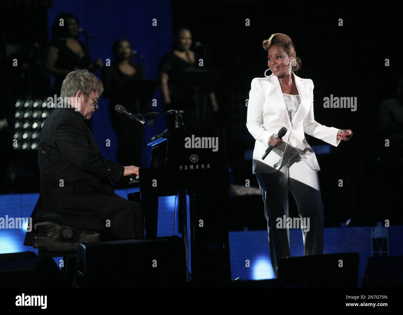 Musicians Elton John, left, and Mary J. Blige, right, perform during the Robin Hood Benefit ...