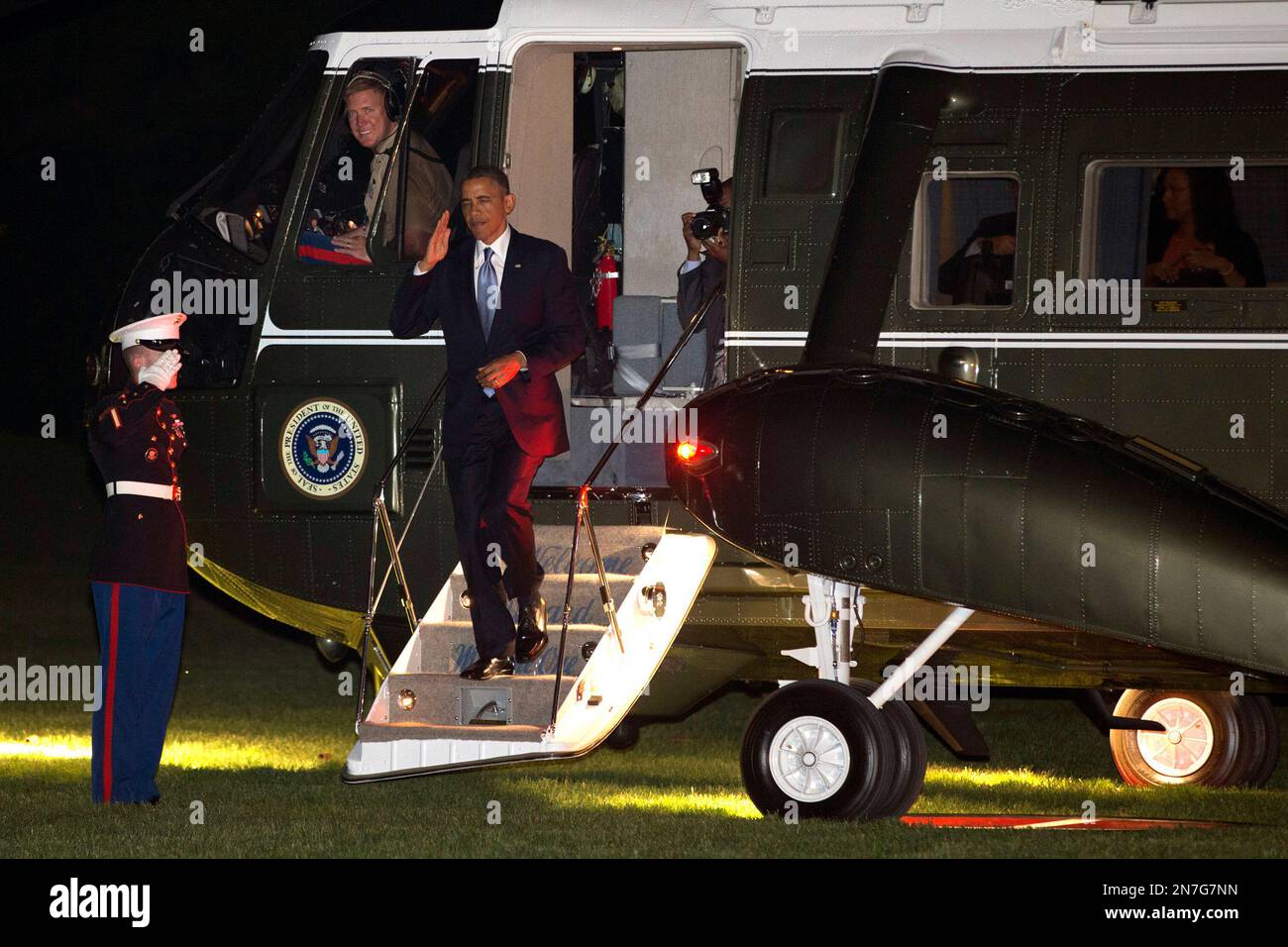 President Barack Obama salutes as a Marine as he returns off the Marine ...