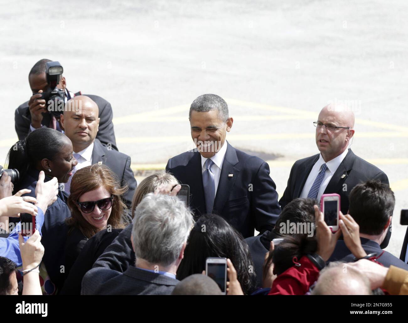 President Barack Obama greets people on the tarmac upon his arrival on ...