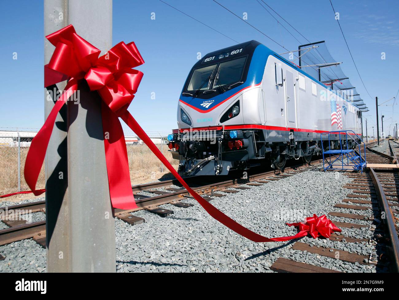 The new Amtrak Cities Sprinter Locomotive passes a red ribbon as it is ...
