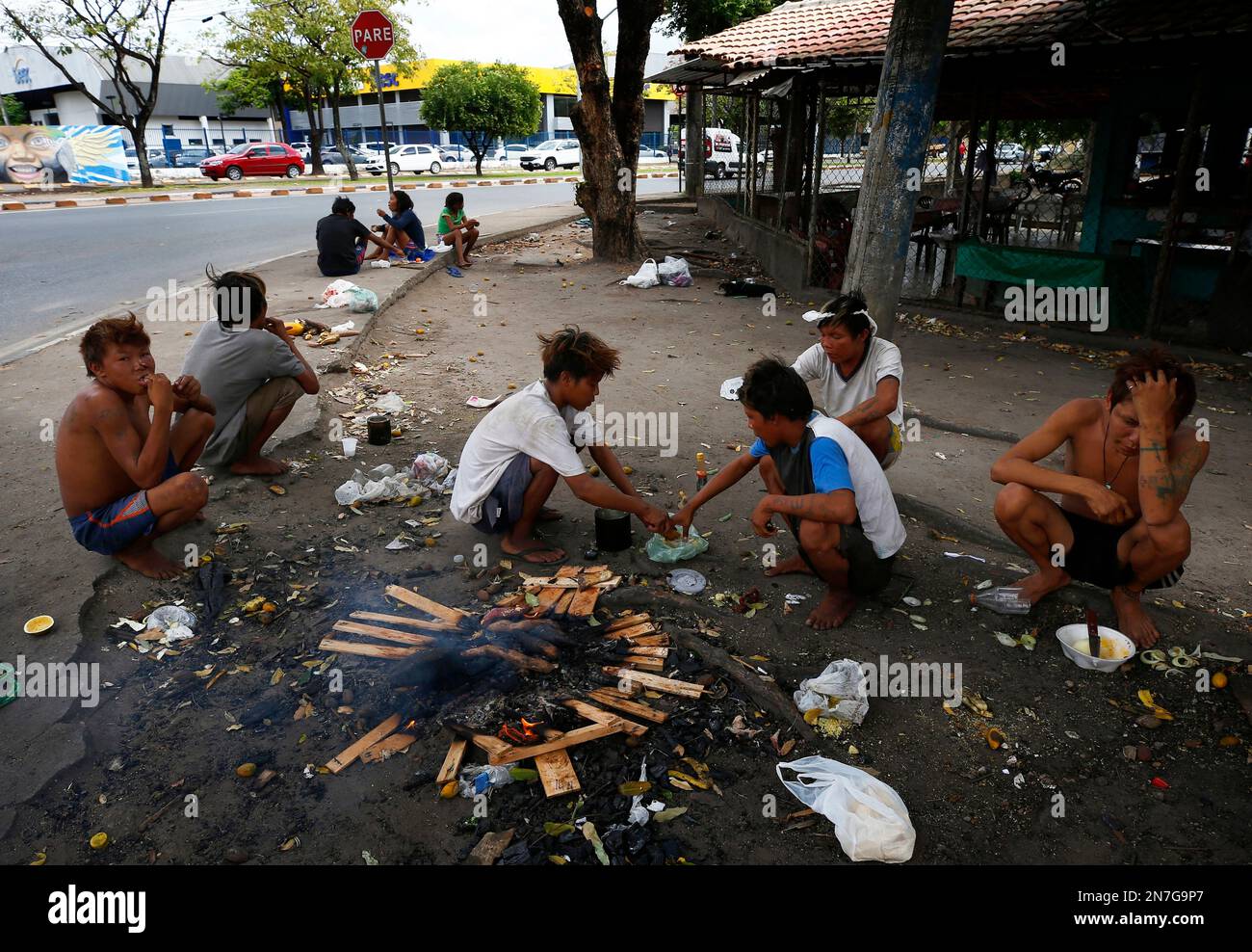 Yanomami Indigenous people eat food cooked on fire in Boa Vista ...