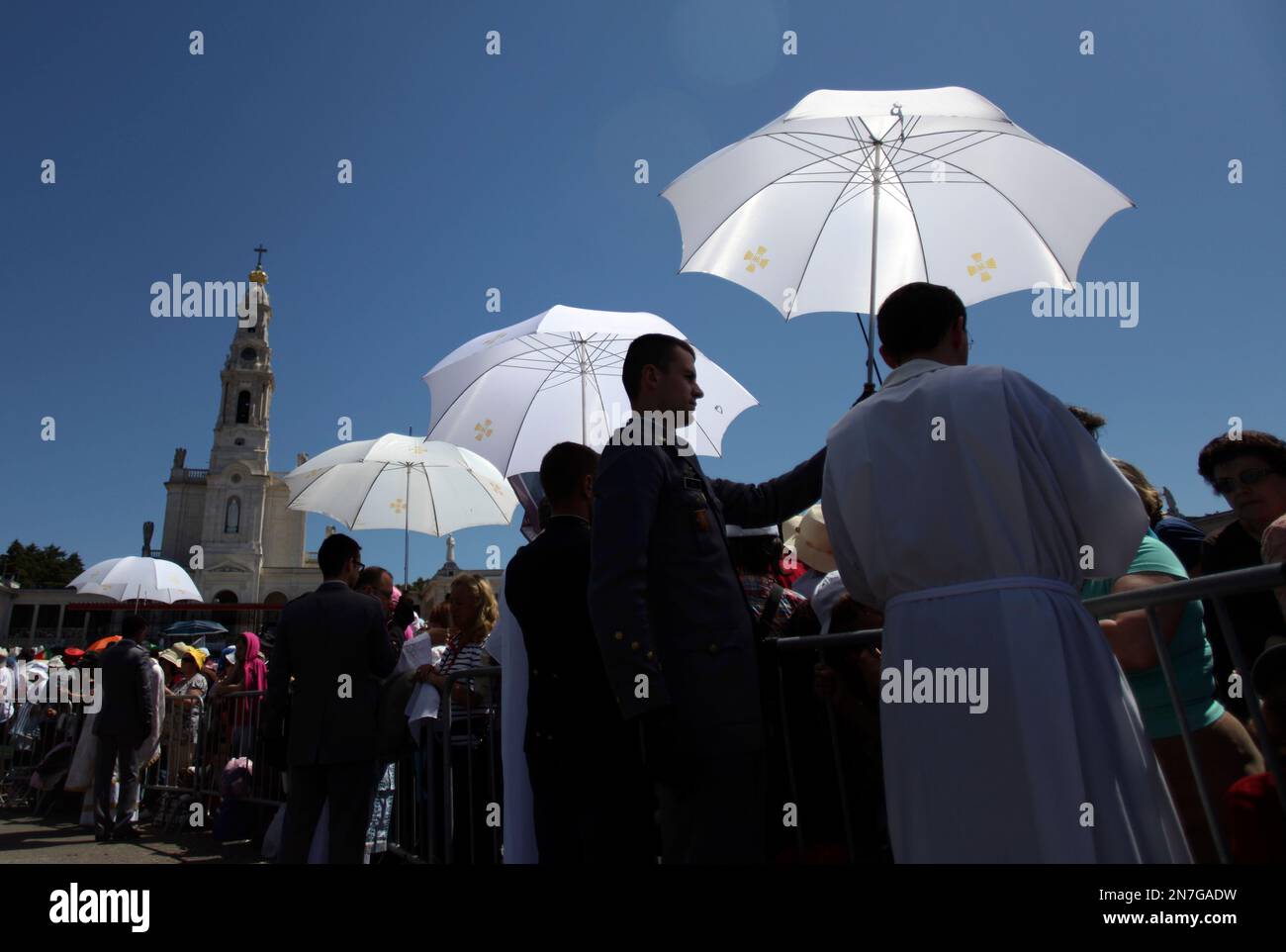 Priests give communion to the faithful during a mass at the Our Lady of ...