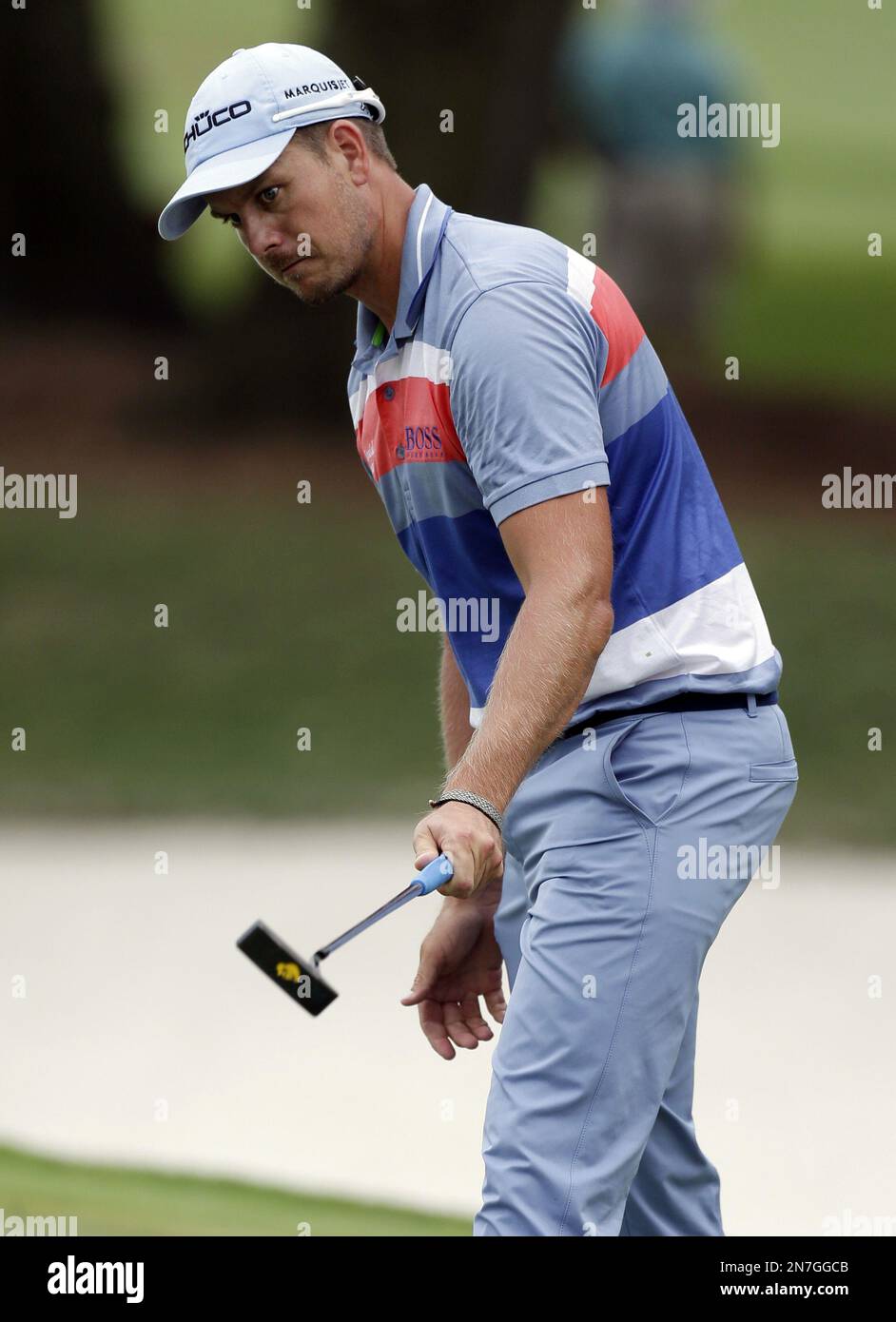 Henrik Stenson, of Sweden, gestures as his ball enters the ninth cup ...