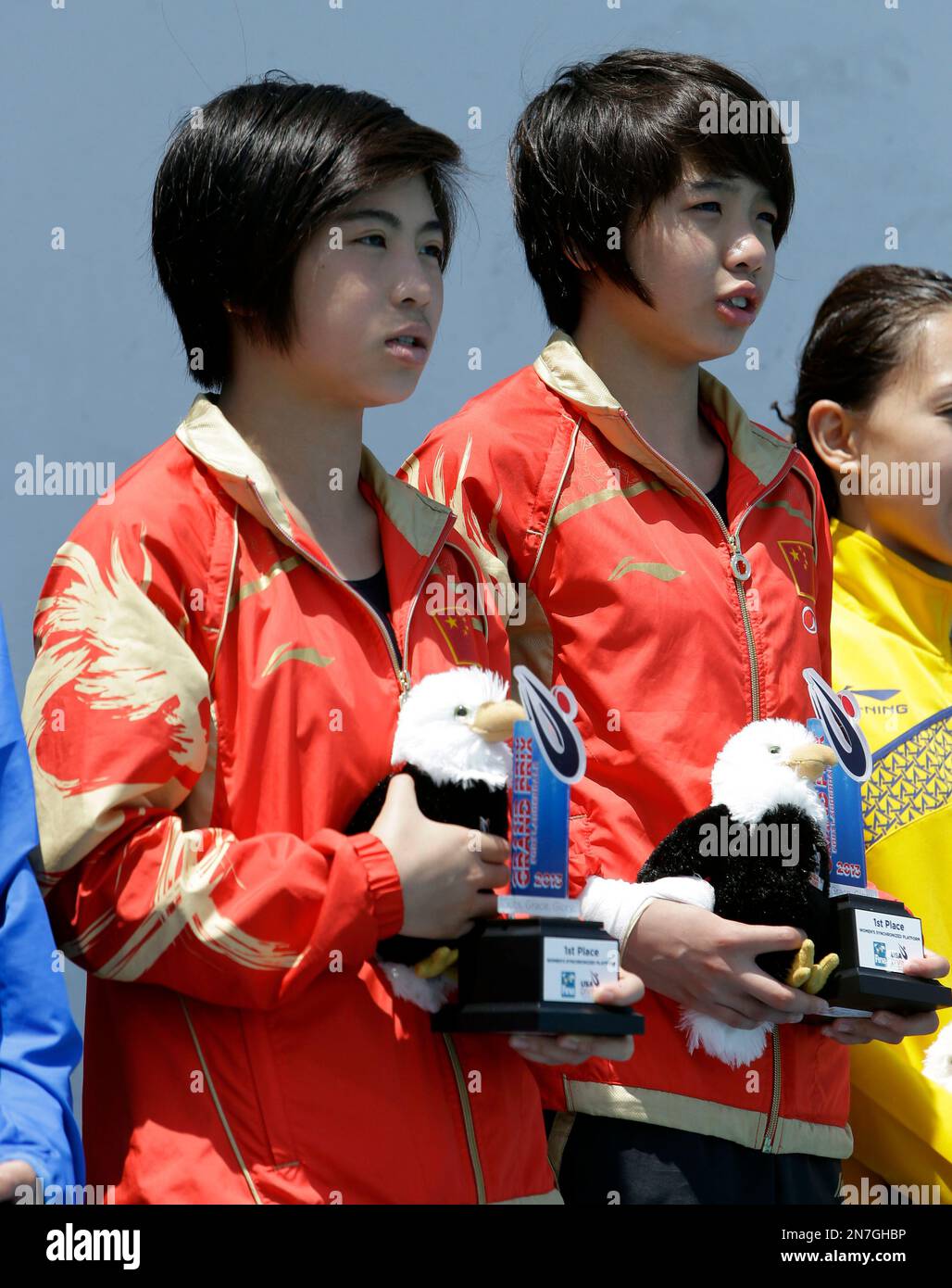 Huang Xiaohui, left, and Jie Lian, right, of China, sing their national ...