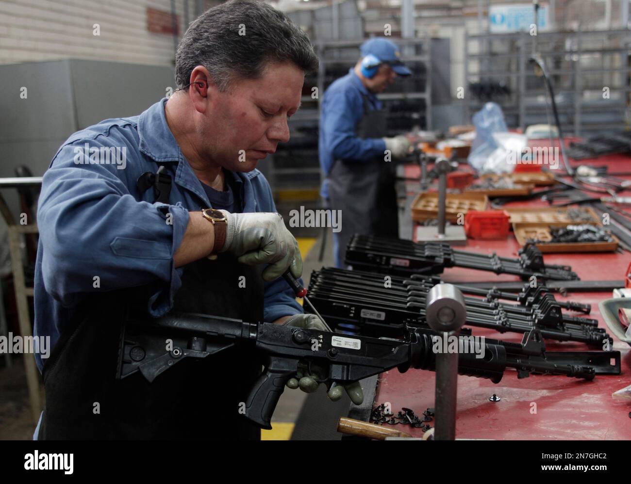 A worker assembles a Galil-GT assault rifle at the Colombian based ...