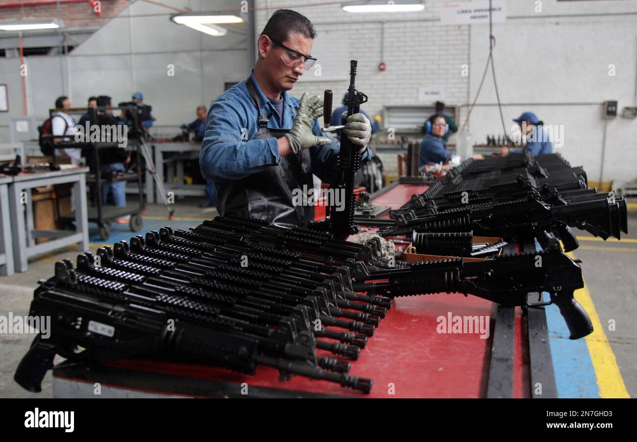 A worker assembles an assault rifle at the Colombian based military ...