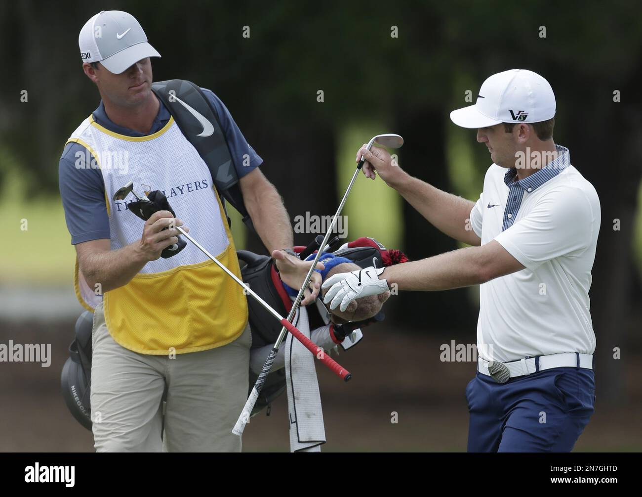 Kevin Chappell, right, switches clubs with his caddie Michael Maness ...