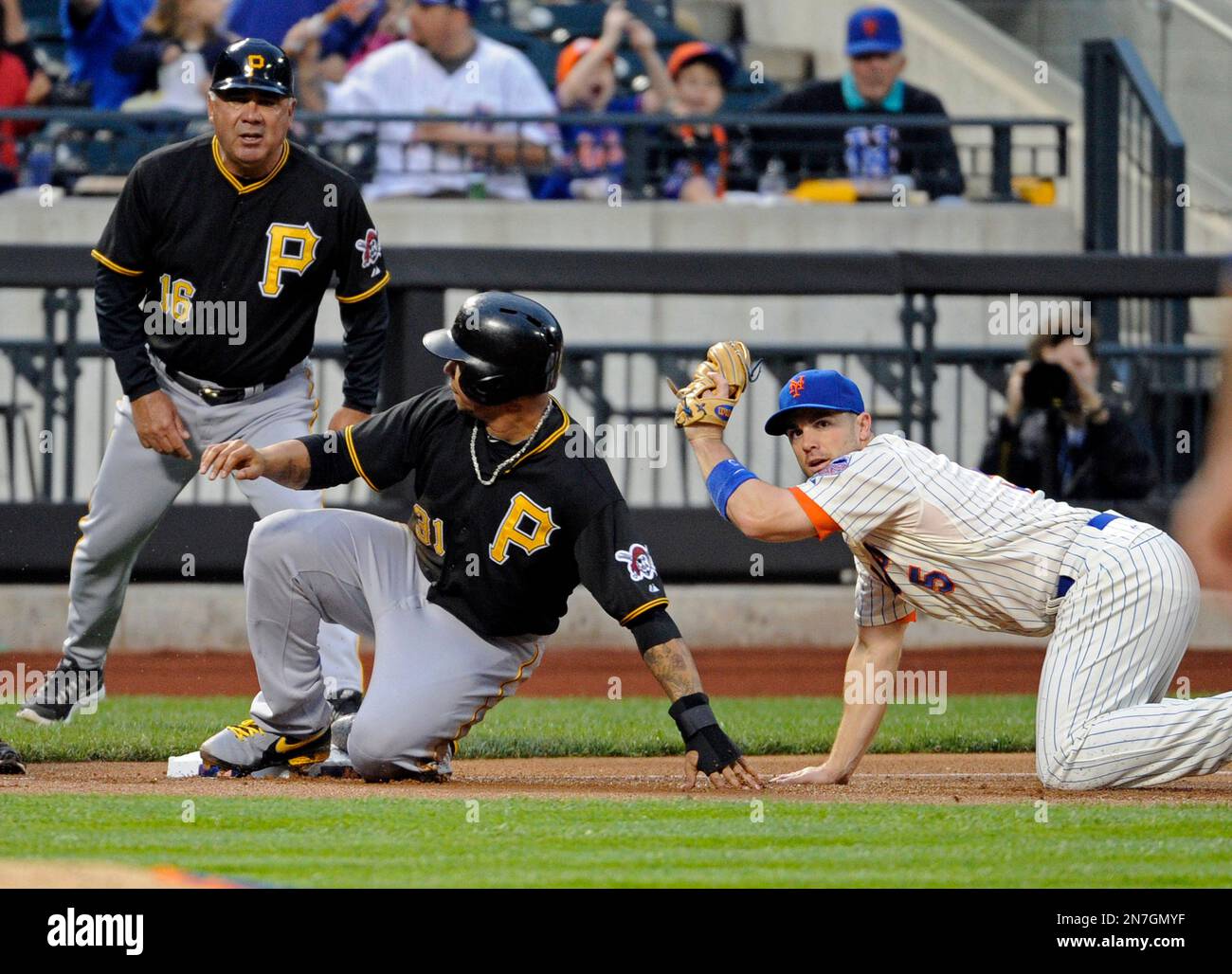 Pittsburgh Pirates' Jose Tabata, center, is tagged out at third base by ...