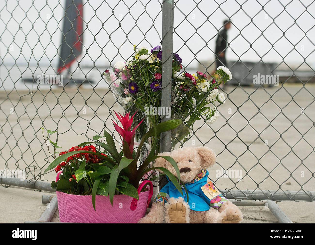 Flowers and a teddy bear form a memorial to British sailor Andrew "Bart ...