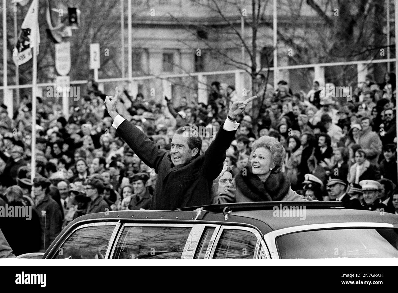 U.S. President Richard Nixon extends his arms and fingers in a "V" sign ...