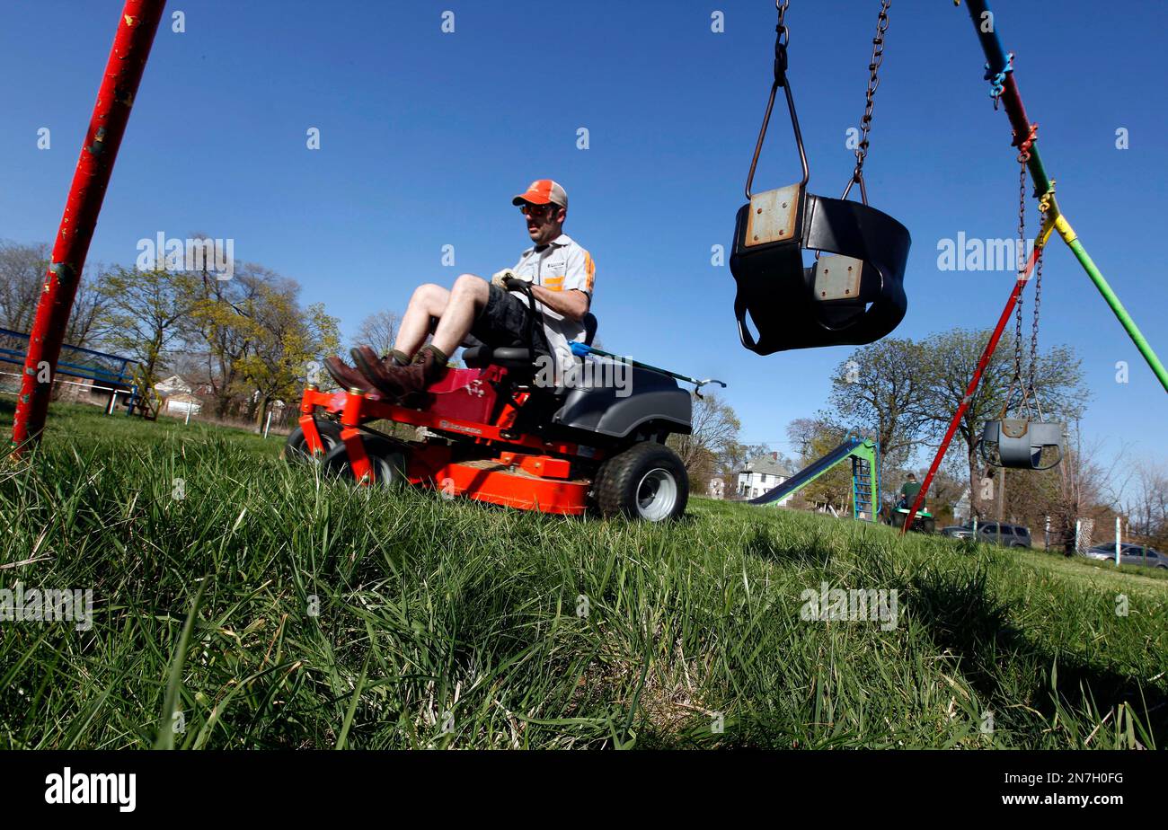 Mower gang member Tom Nardone, of Birmingham, drives a riding mower at ...