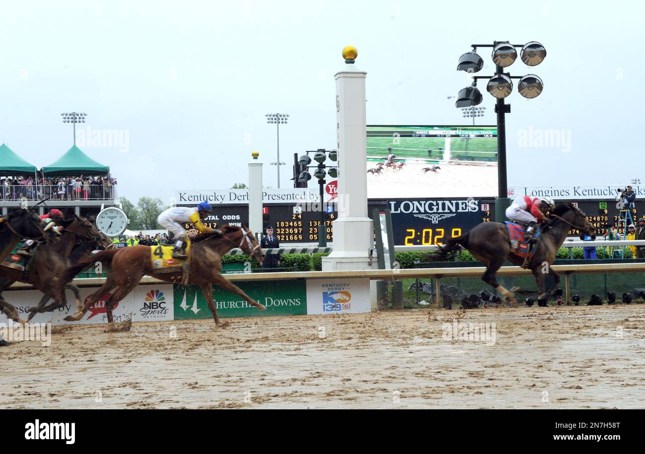 Orb, right, races by the Longines chronometer as he wins the 139th ...