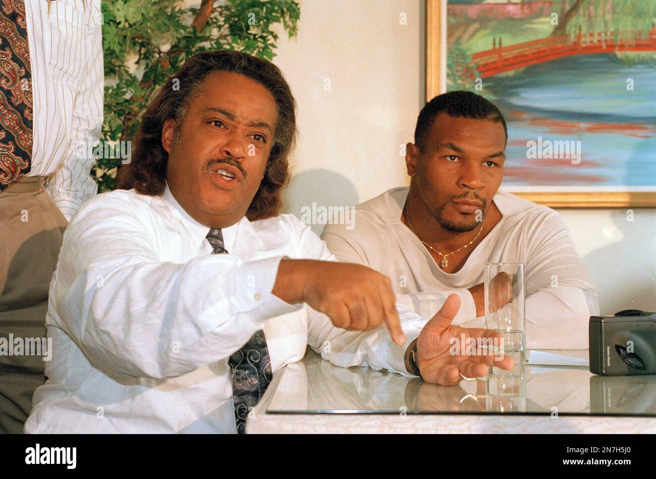Ex-heavyweight champion Mike Tyson, right, listens as the Rev. Al ...