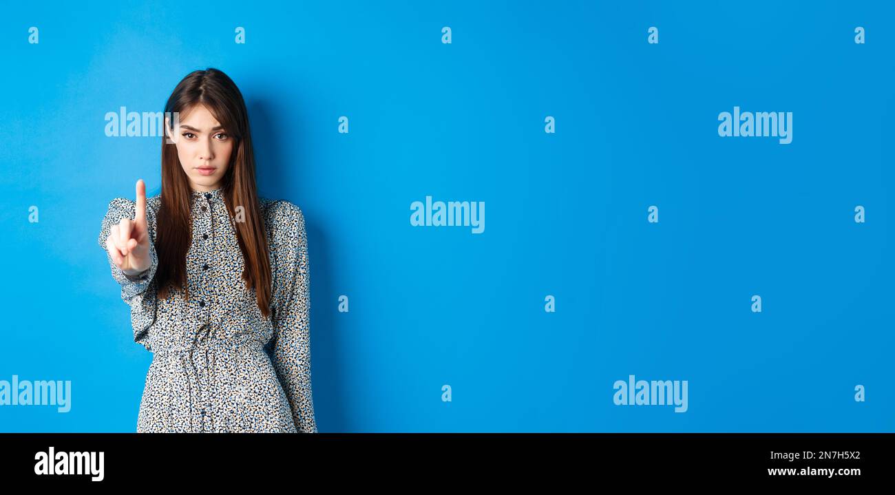 Serious woman looking confident and shaking finger, say no, stop you ...