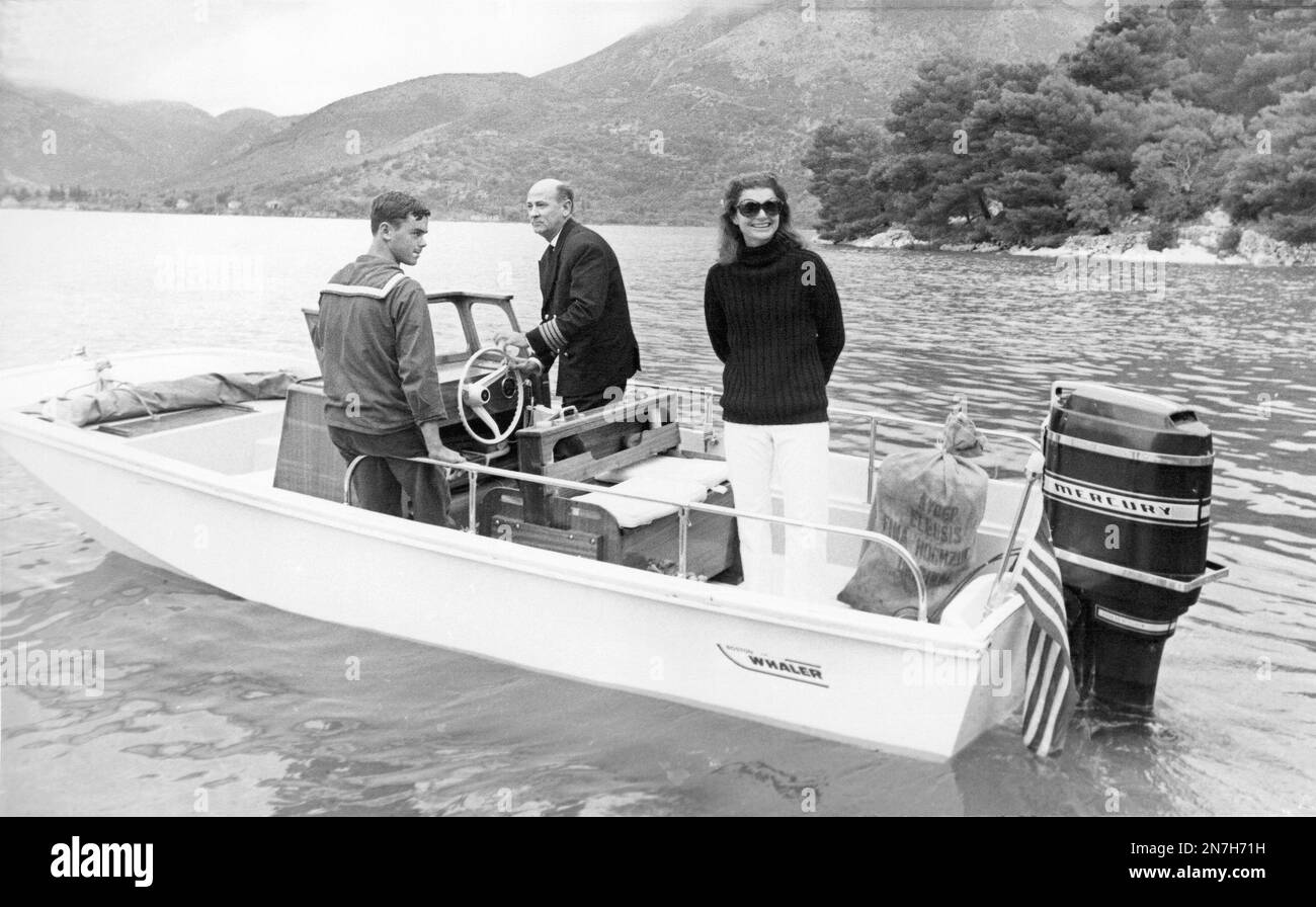 Jacqueline Onassis is shown on board a speed boat setting out for a ...