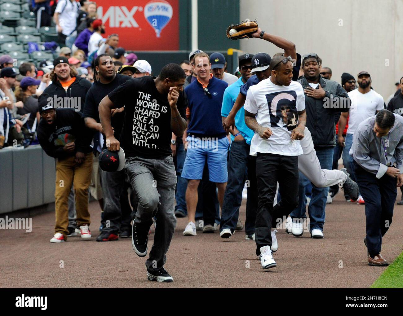 New York Yankees bullpen coach Mike Harkey jumps to catch a long ball ...