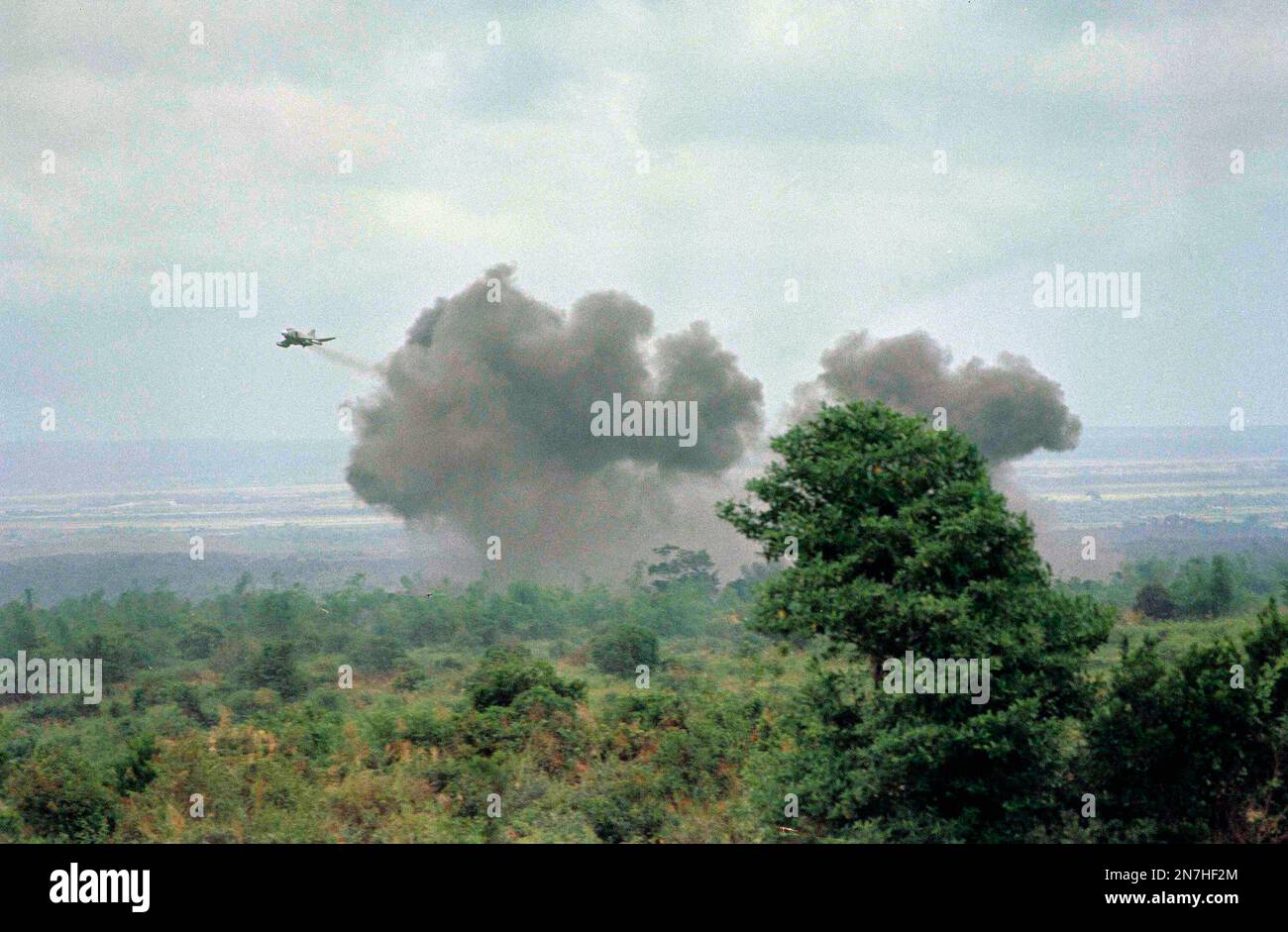 U.S. jet drops napalm and explosives on Viet Cong positions 17 miles ...