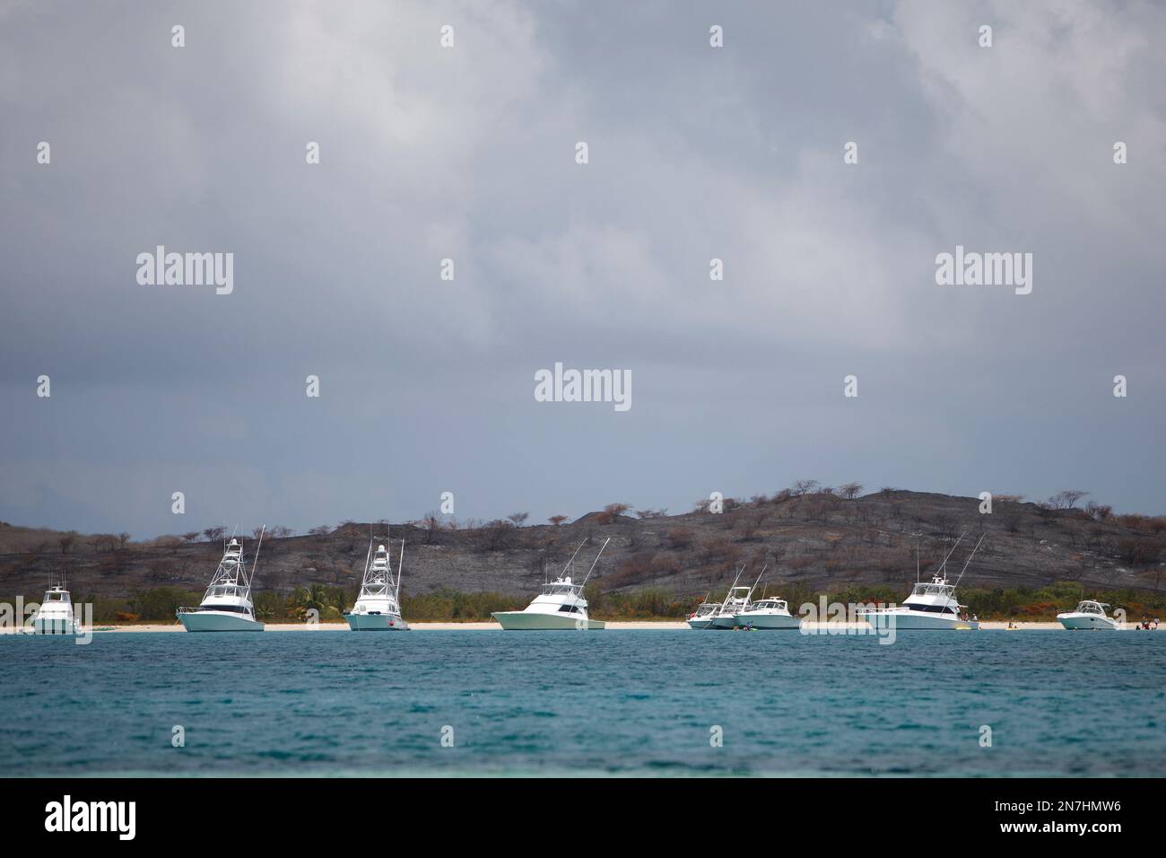 Yachts sit anchored off a beach in what was once a U.S. Naval Training ...