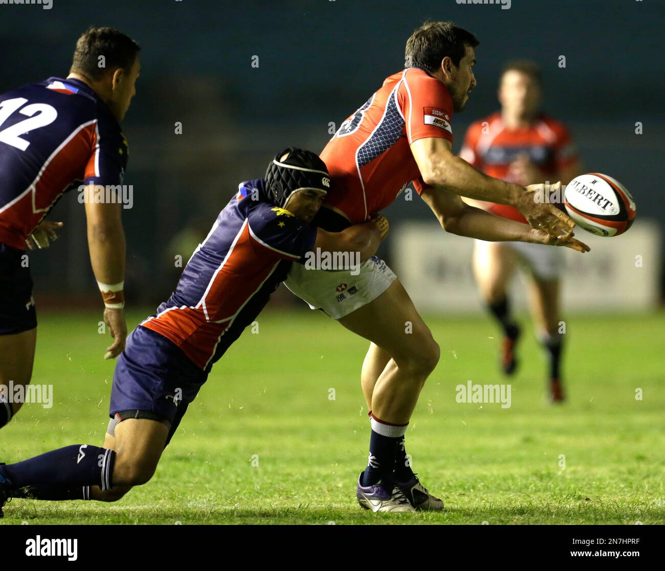 The Philippine Volcanoes' Michael Duhig, center, attempts to tackle Tom ...