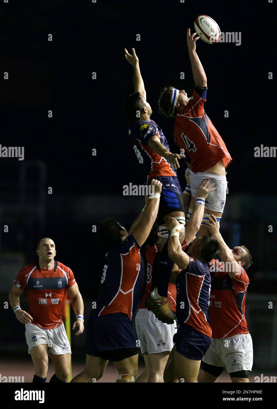 Hong Kong's Ian Ridgeway (4) is lifted by teammates to catch the ball ...