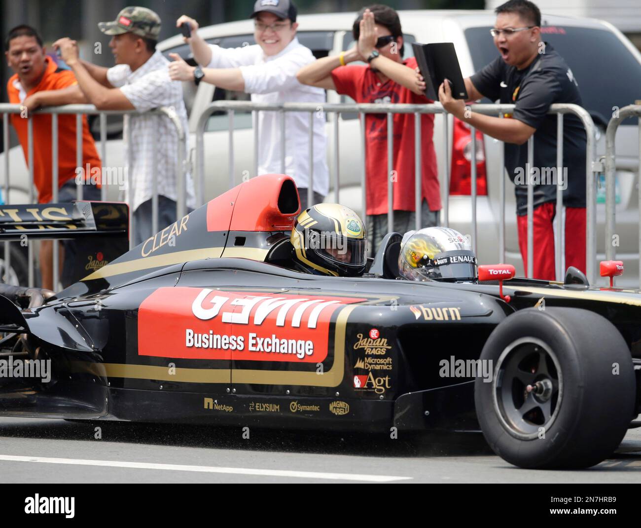 Filipino fans cheer at Manila Mayor Alfredo Lim riding at the back with ...