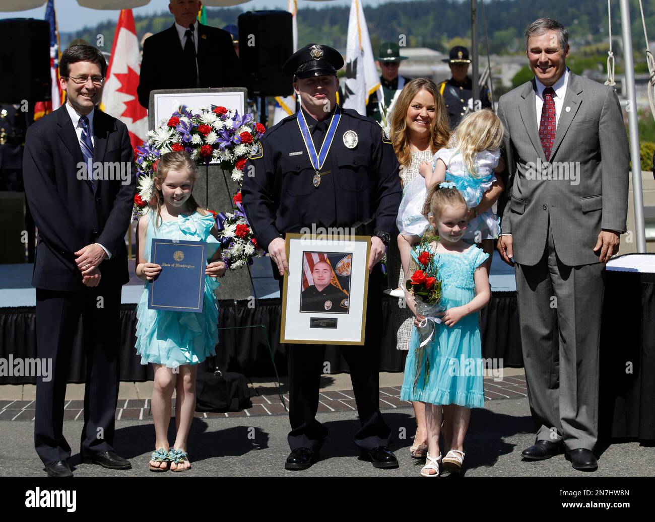 Lakewood Police officer Ryan Moody, center, poses for a photo with Gov ...