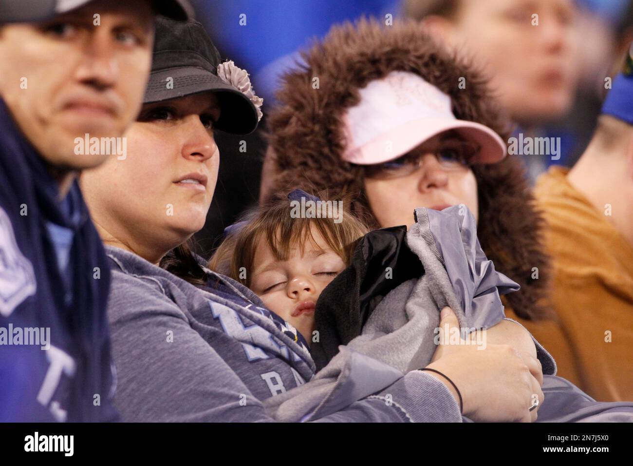 Kansas City Royals fans sit as the temperature falls at a baseball game ...