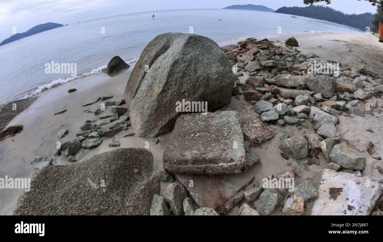 huge boulders laying along the sandy beach Stock Photo - Alamy