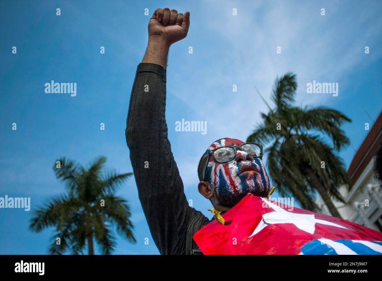 A Papuan rises his fist as he displays "Morning Star" separatist flags ...