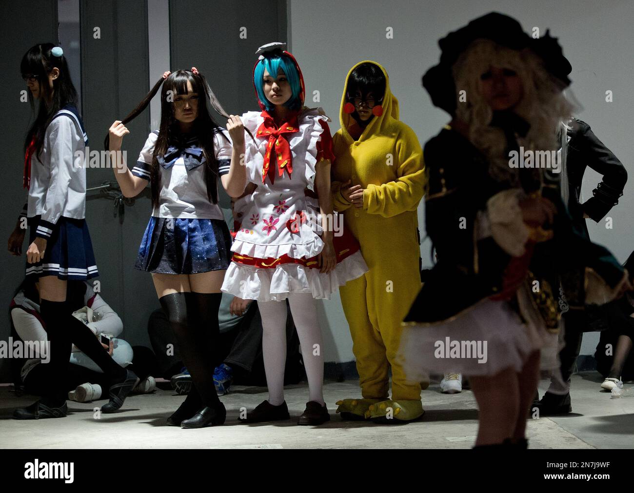 Chinese cosplay enthusiasts dressed as cartoon characters line-up while ...