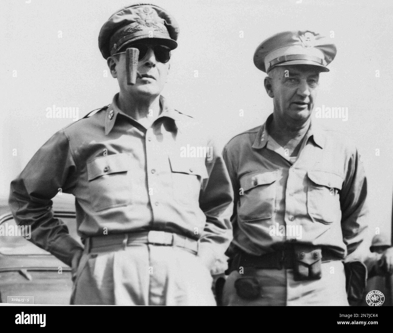 Gen. Douglas MacArthur, left, enjoying his fames corncob pipe, meets Lt ...