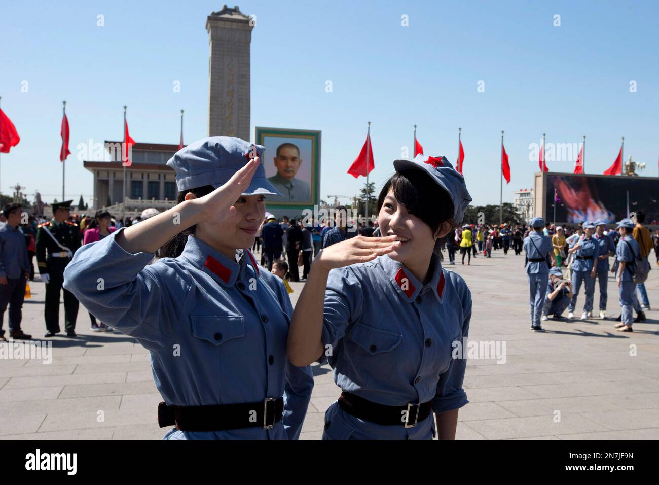 Chinese girls dressed to look like Chinese Red Army soldiers salute for ...