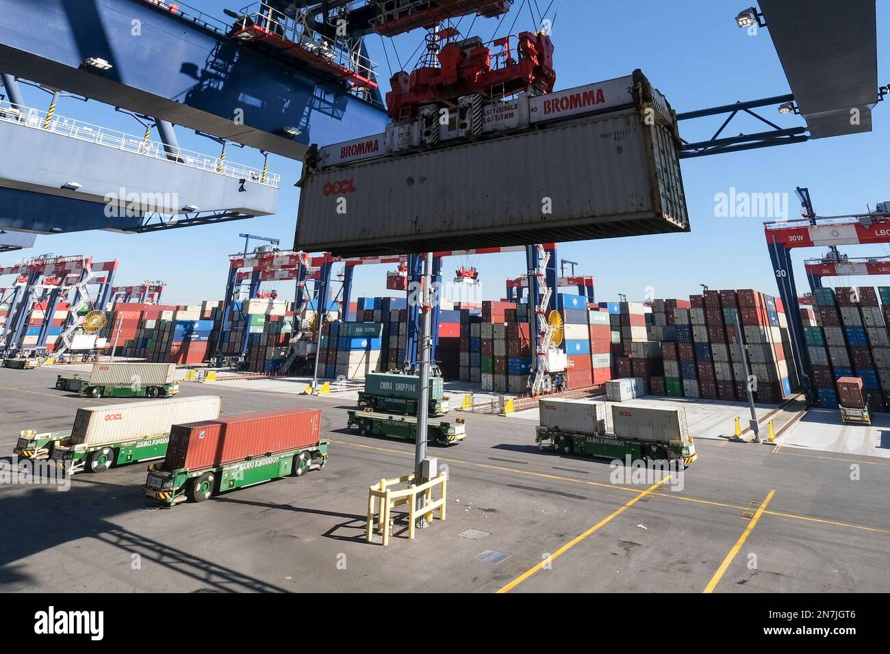 Computer-controlled cargo cranes rapidly lift containers from ships to ...