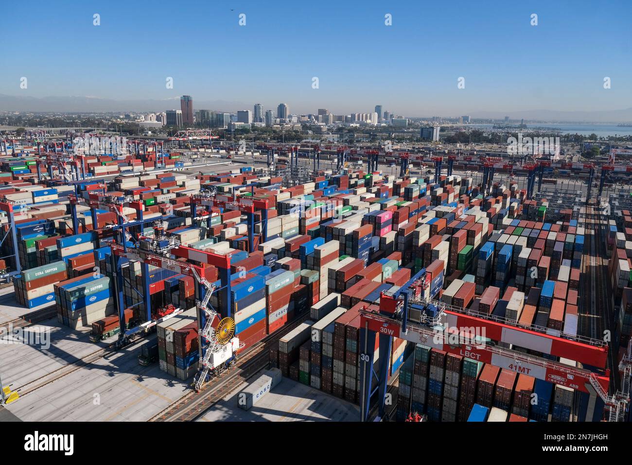 Stacked shipping containers wait to move by Automated Staking Cranes ...