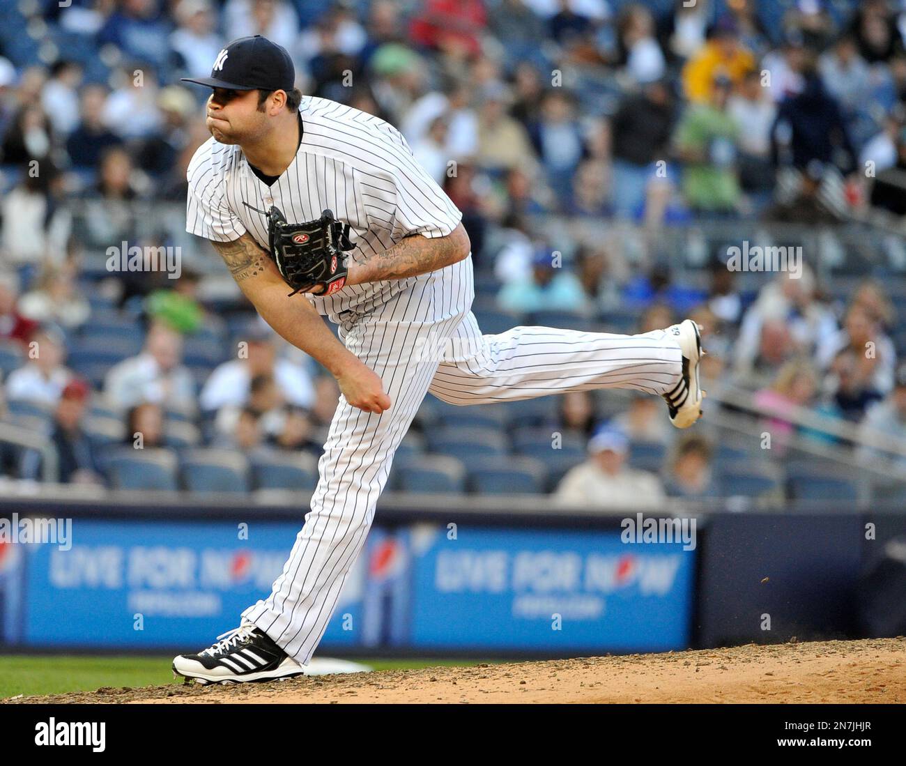 New York Yankees relief pitcher Joba Chamberlain closes the baseball ...