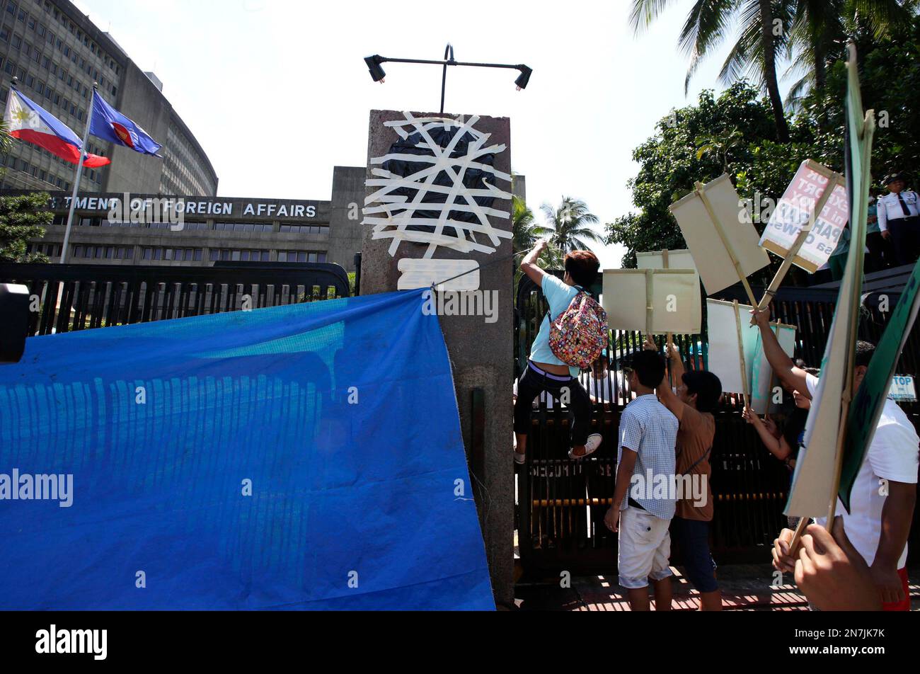 Relatives of OFWs (Overseas Filipino Workers) display placards as they ...