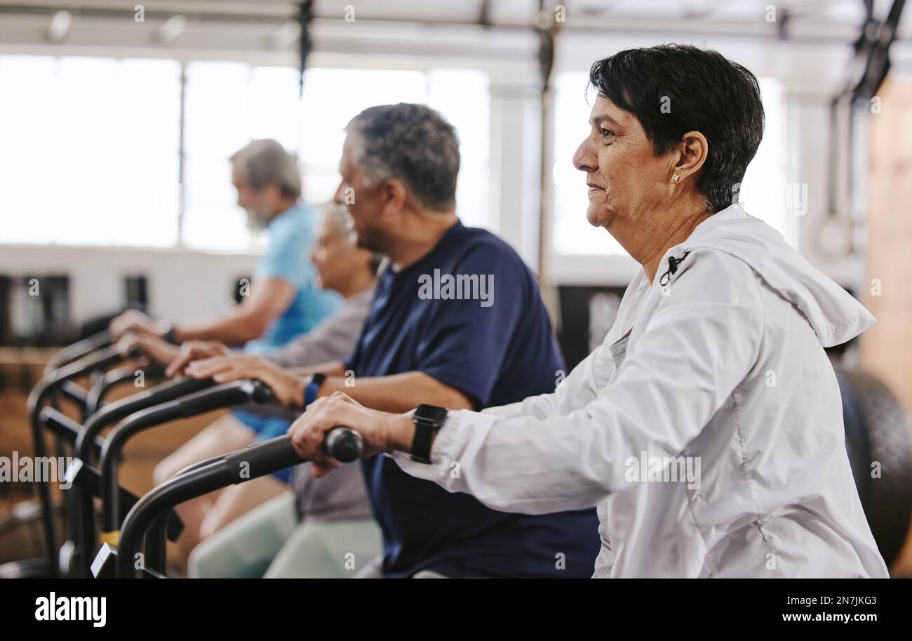 Senior workout group, exercise bike and cycling for fitness, health and ...