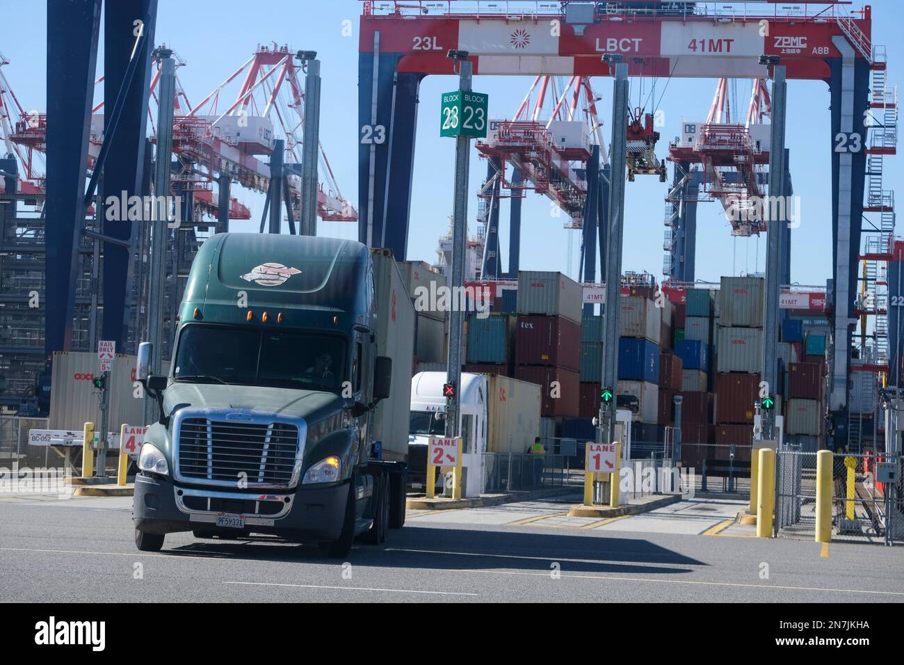Trucks wait to receive containers at the Long Beach Container Terminal ...