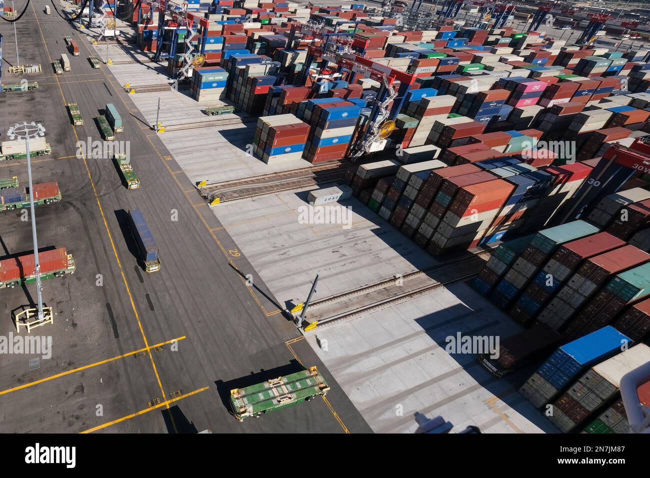 Stacked shipping containers wait to move by Automated Staking Cranes ...