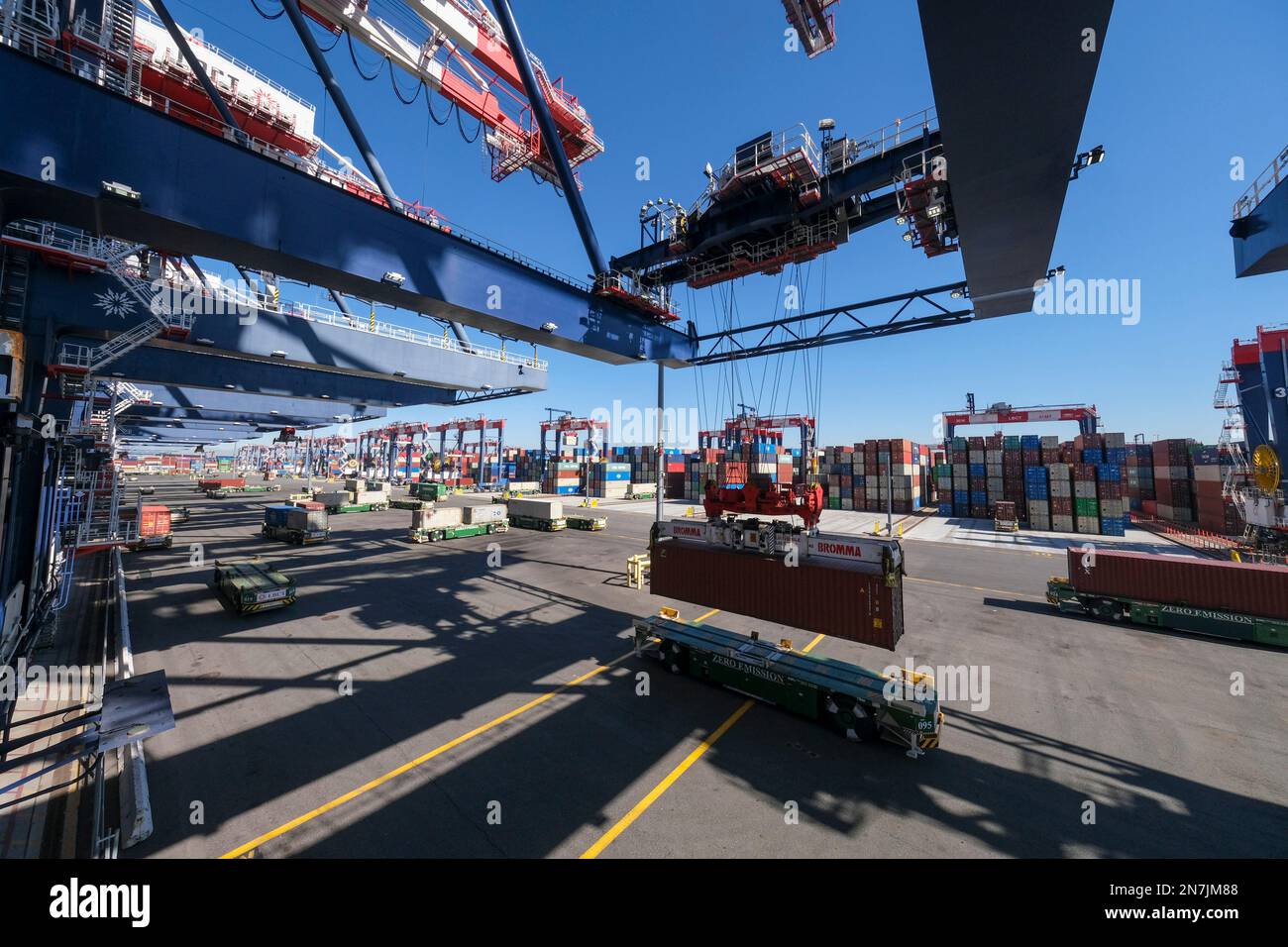 Computer-controlled cargo cranes rapidly lift containers from ships to ...