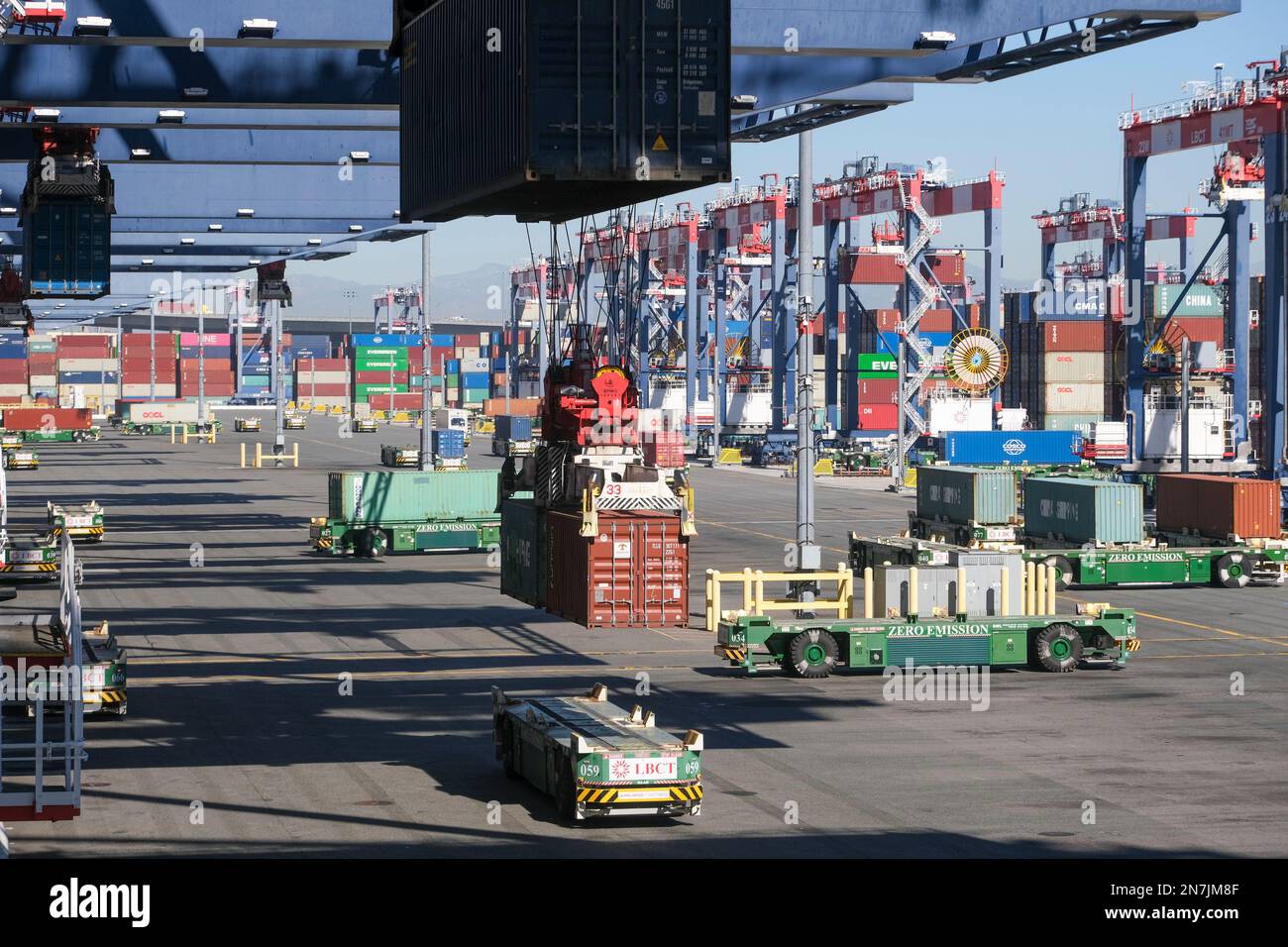 Computer-controlled cargo cranes rapidly lift containers from ships to ...