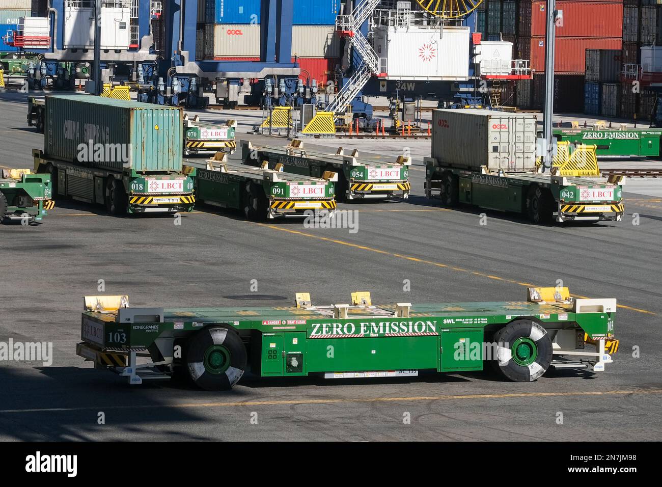 Computer-controlled cargo cranes rapidly lift containers from ships to ...