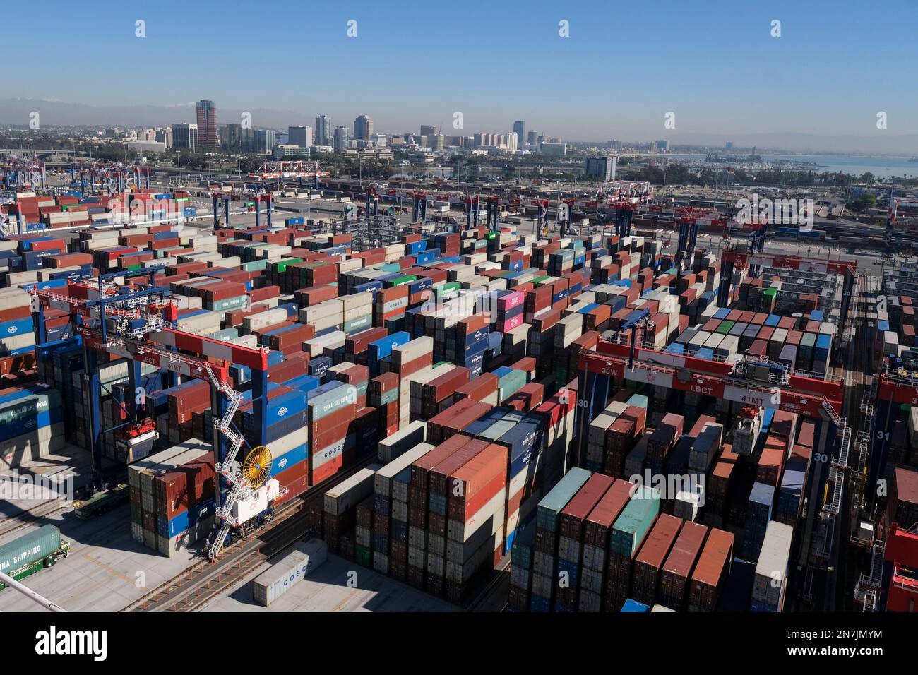Stacked shipping containers wait to move by Automated Staking Cranes ...