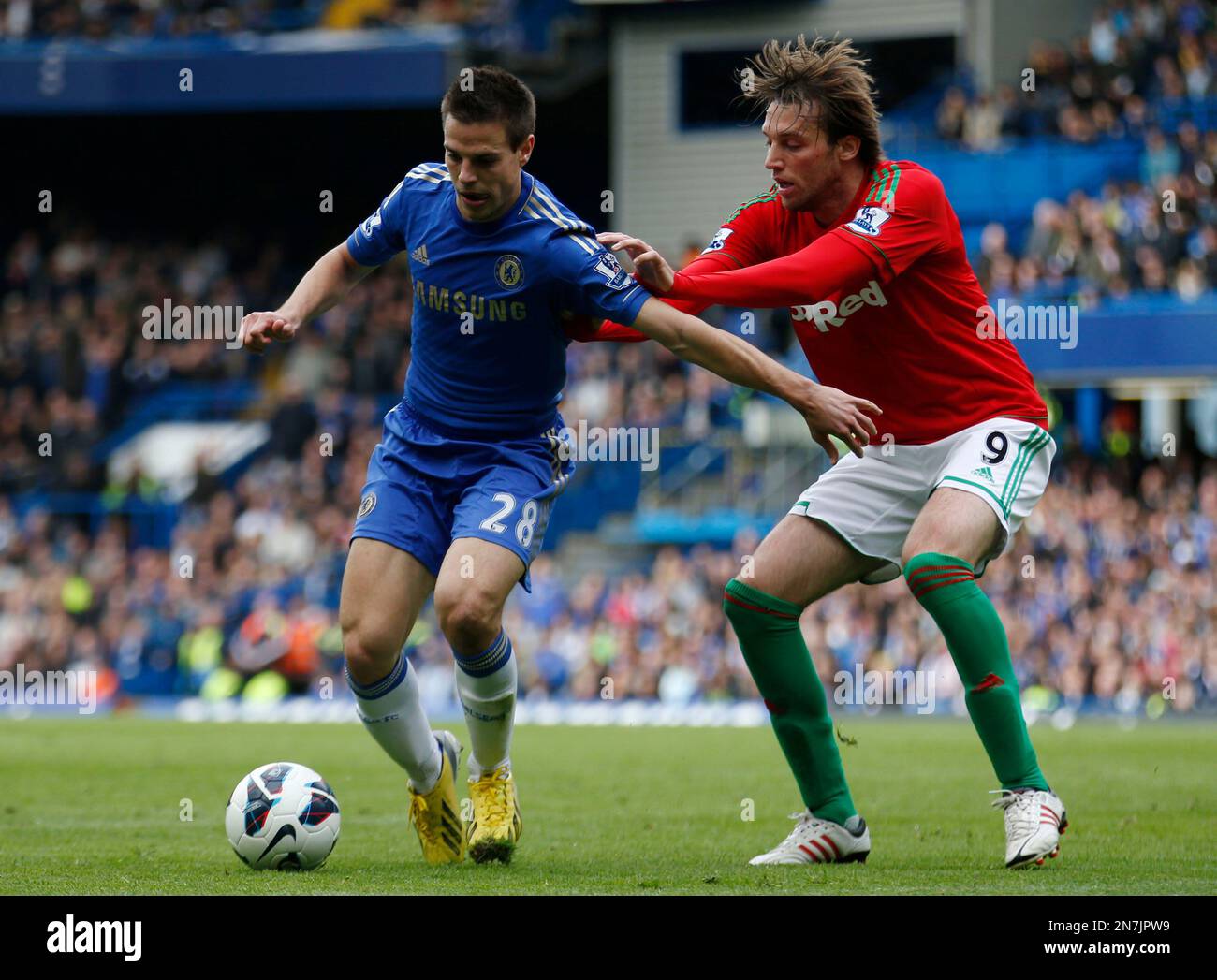 Chelsea's Cesar Azpilicueta, left, competes with Swansea City's Miguel ...