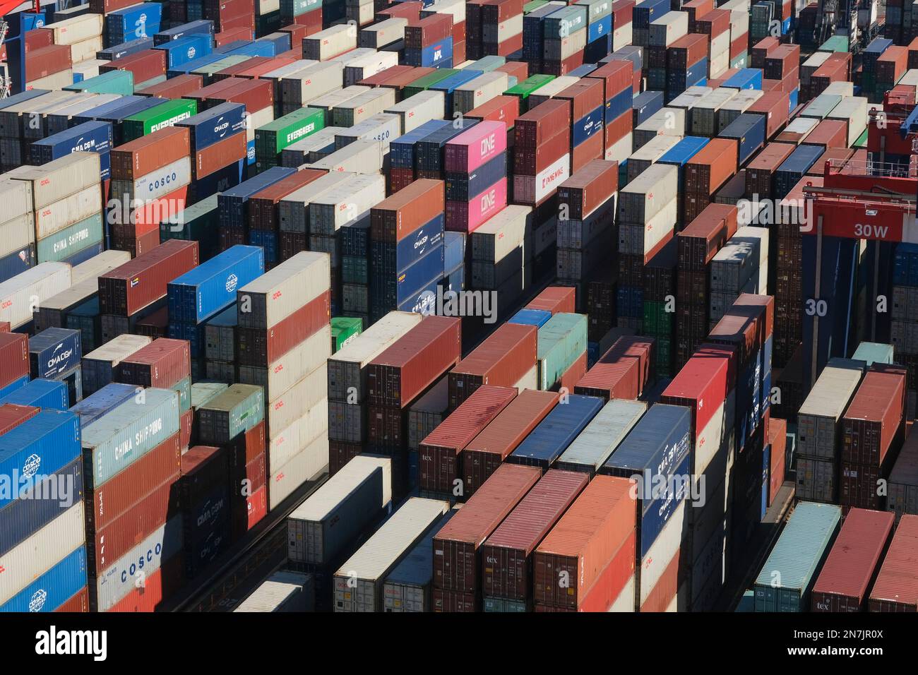 Stacked shipping containers wait to move by Automated Staking Cranes ...