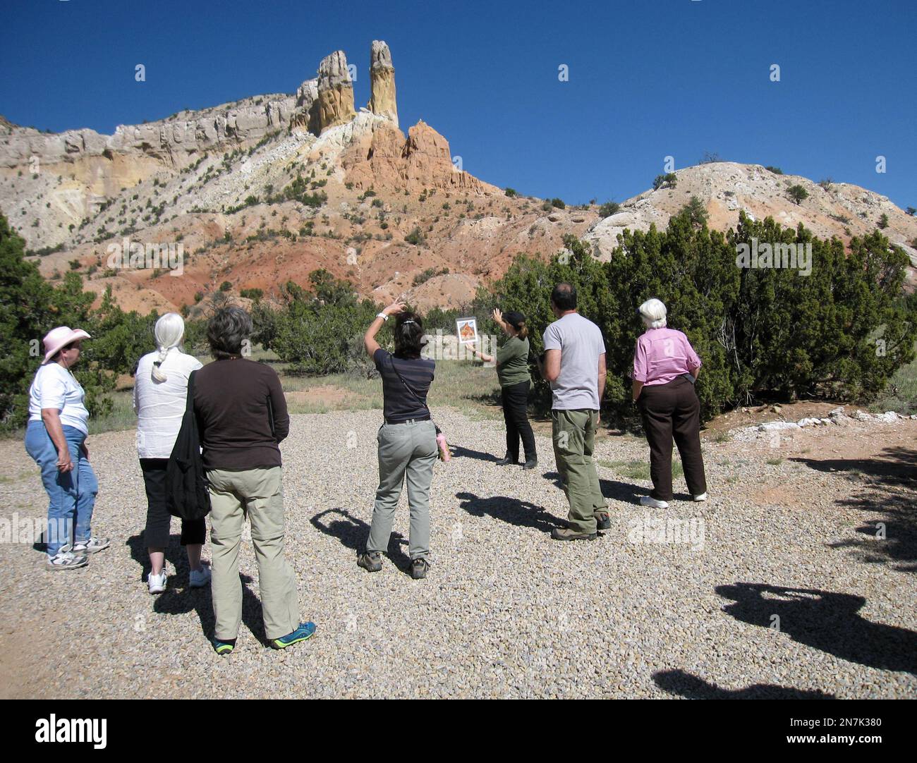 This October 2012 photo shows a tour guide holding up an image of a ...
