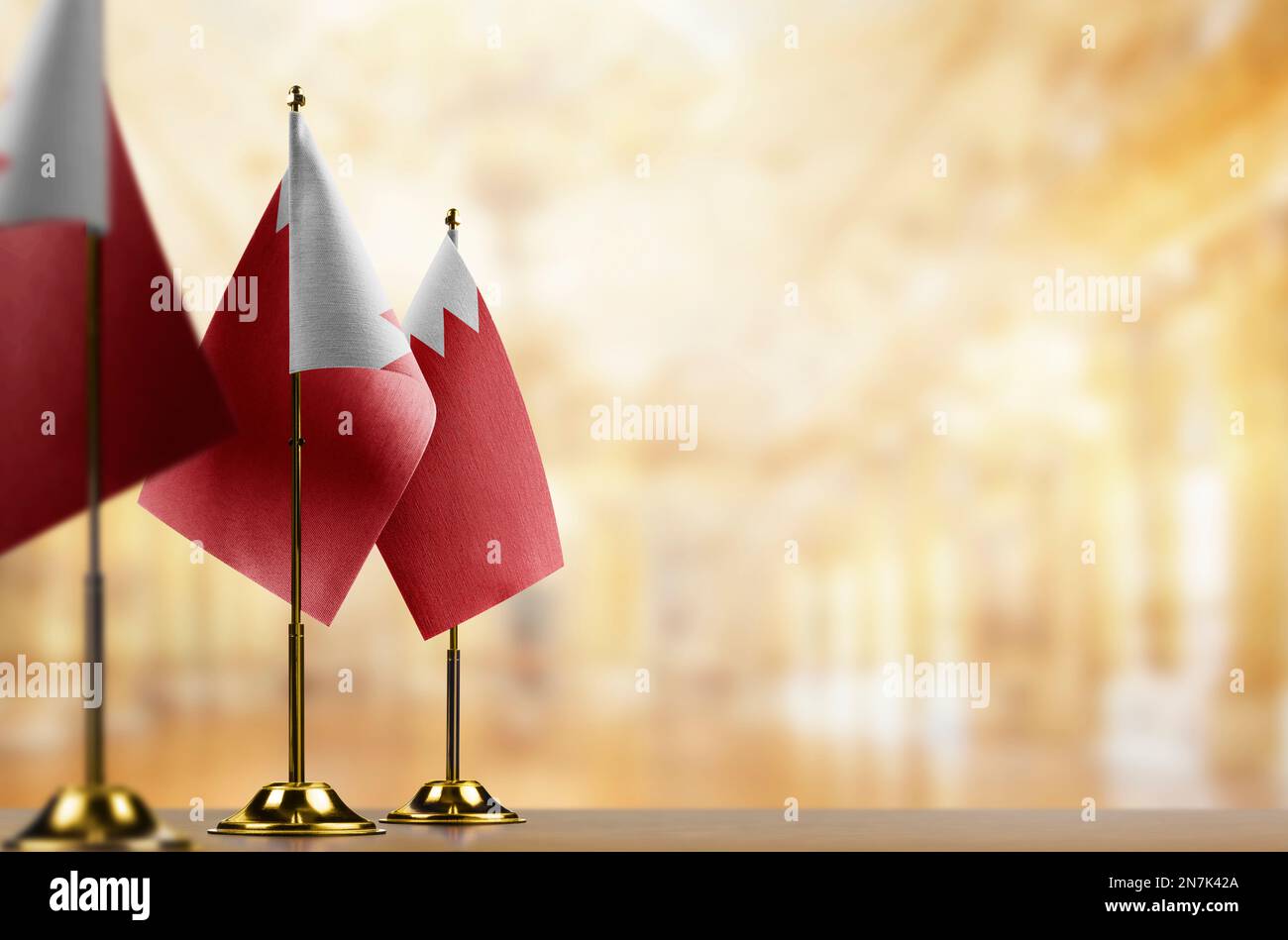 Small flags of the Bahrain on an abstract blurry background Stock Photo ...