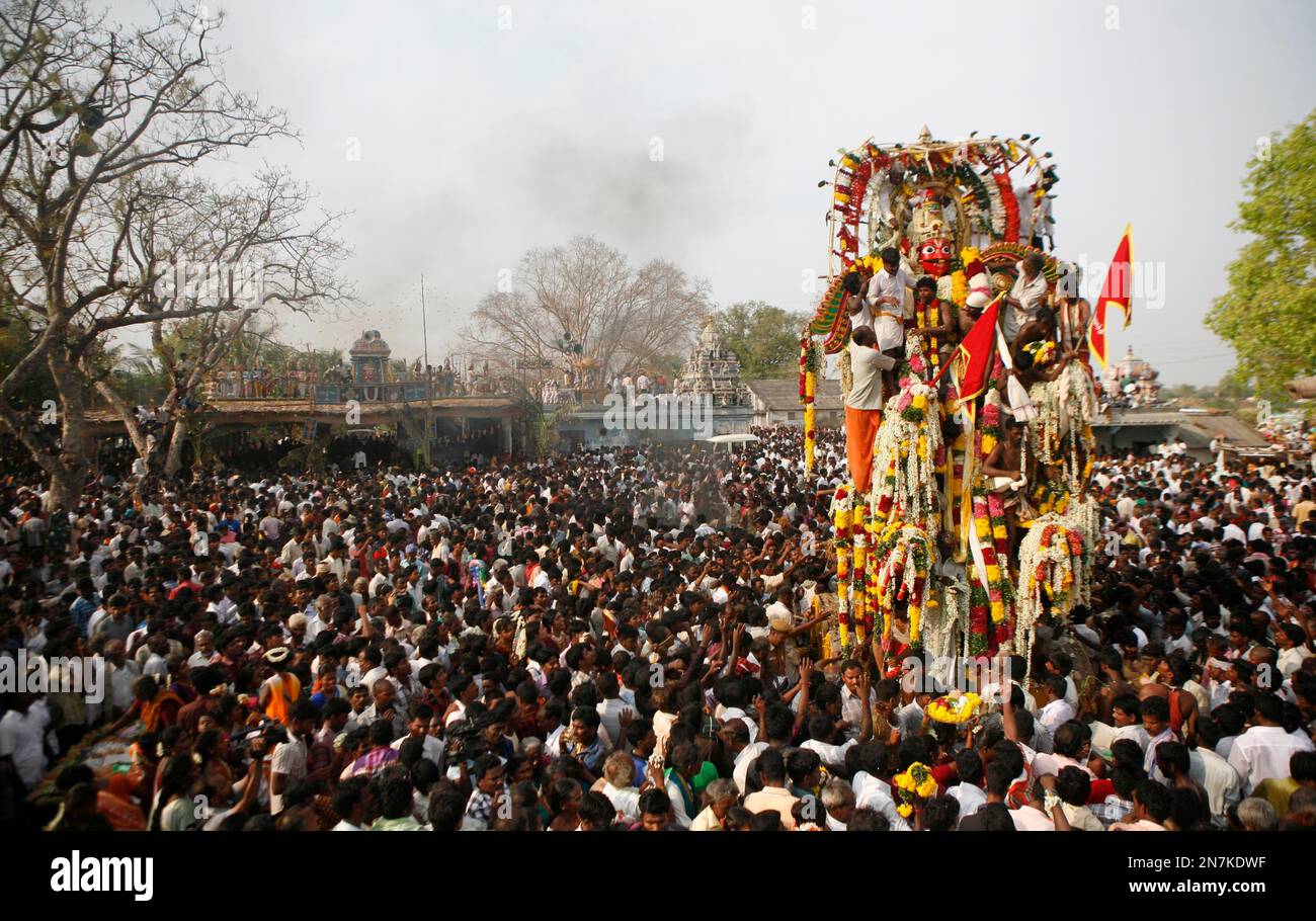 An idol of warrior god Aravan is taken in a chariot during the annual ...