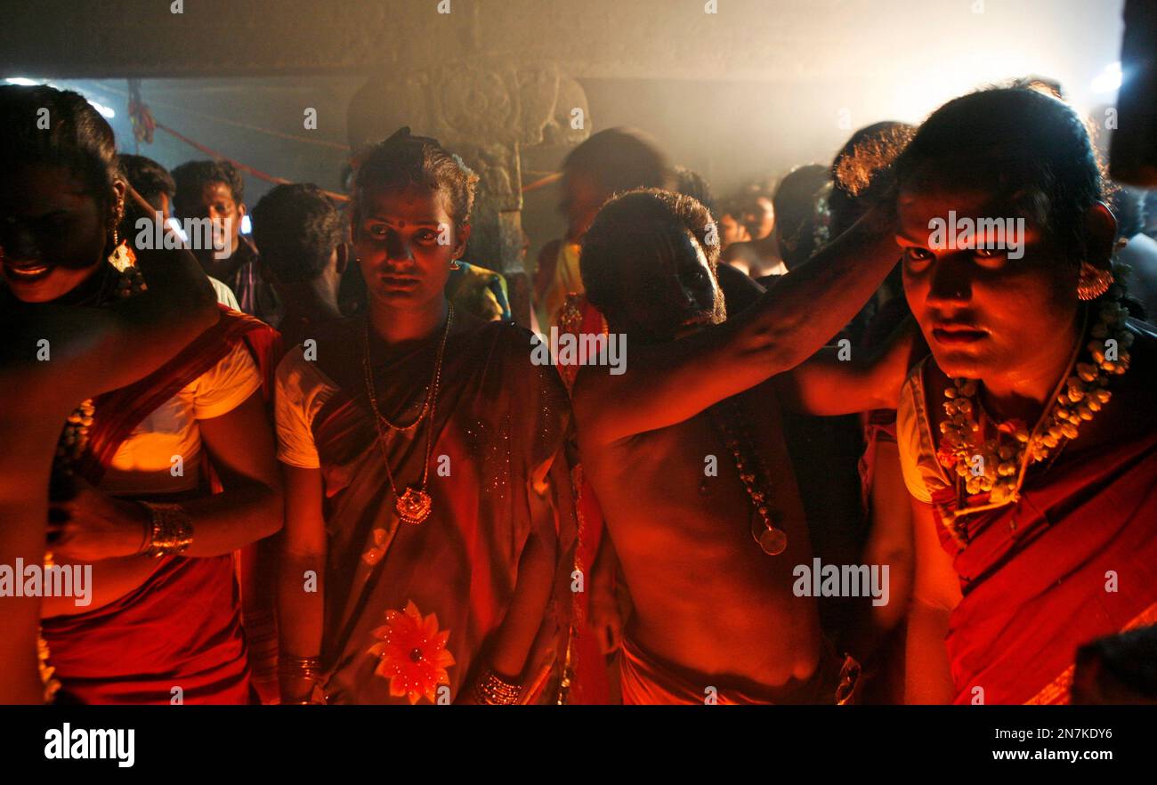 In this Tuesday, April 23, 2013 photo, a temple priest ties a holy ...