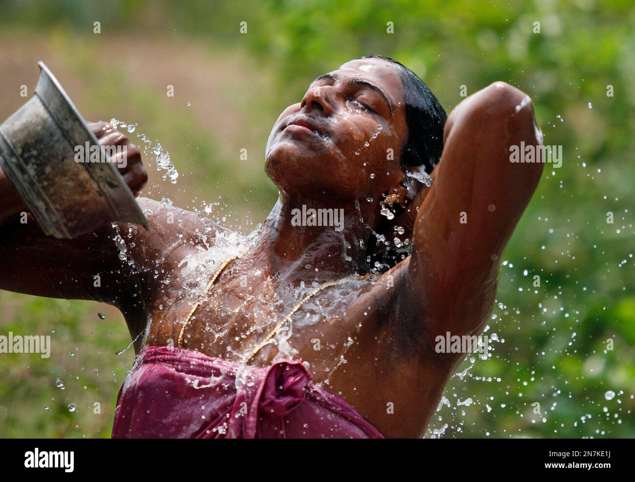 In this Monday, April 22, 2013 photo, an Indian eunuch bathes before ...